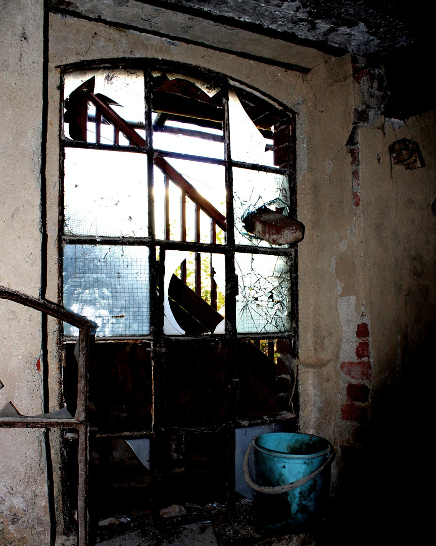 You can see decay through the old window in a forgotten building ...